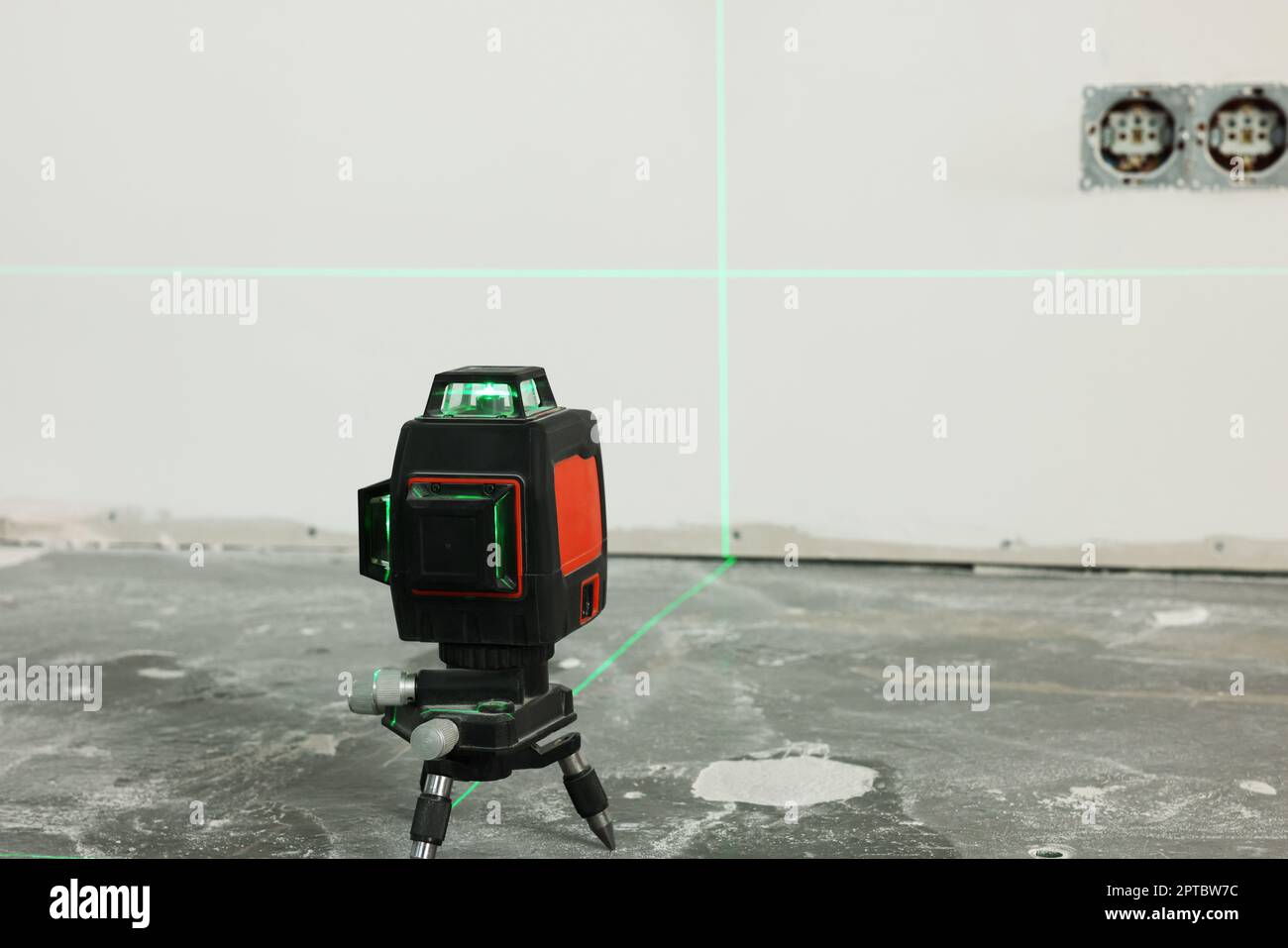 Laser level on floor near electrical sockets Stock Photo - Alamy