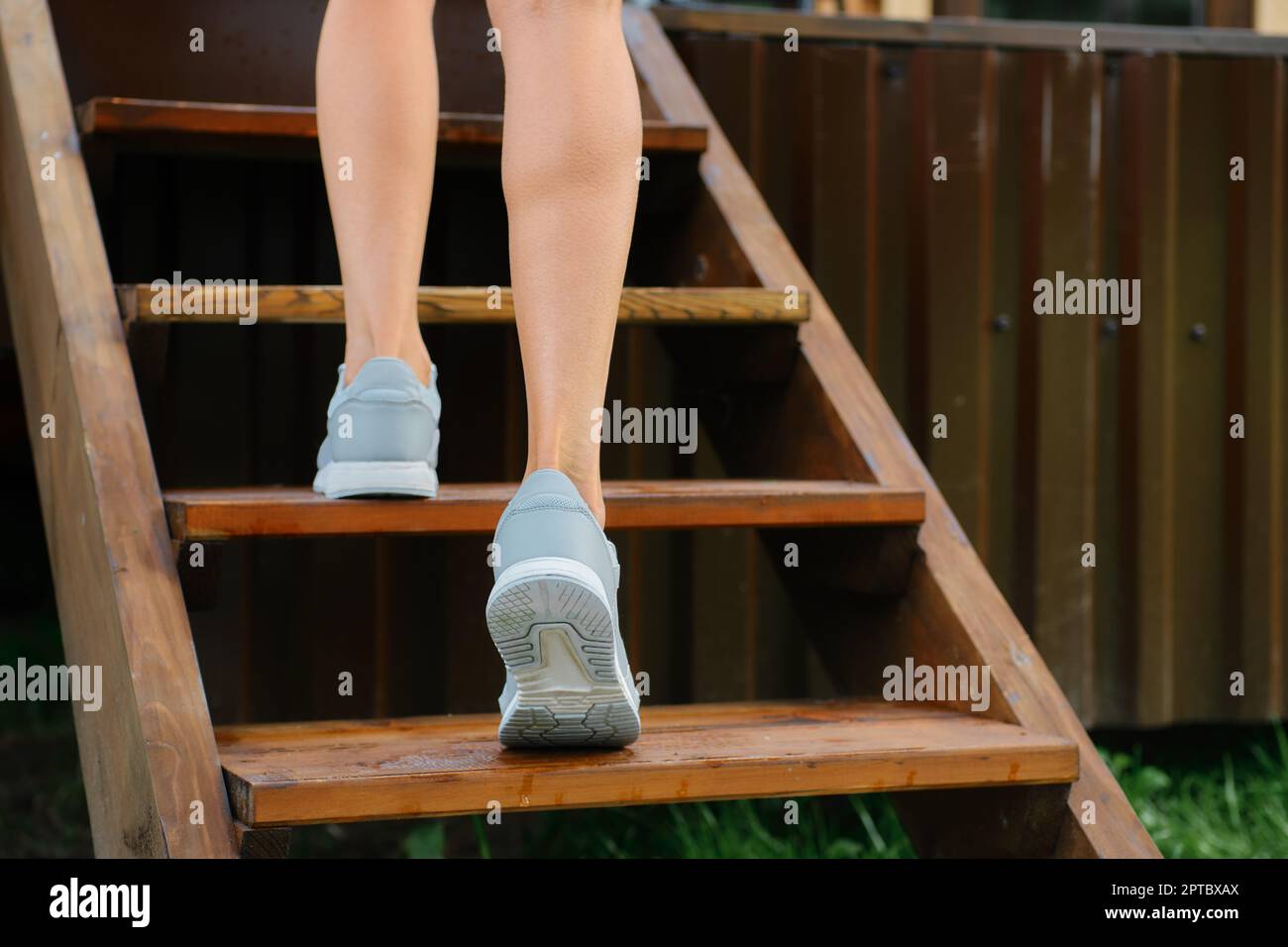 Back view of sporty female legs in sneakers ascending the stairs Stock ...