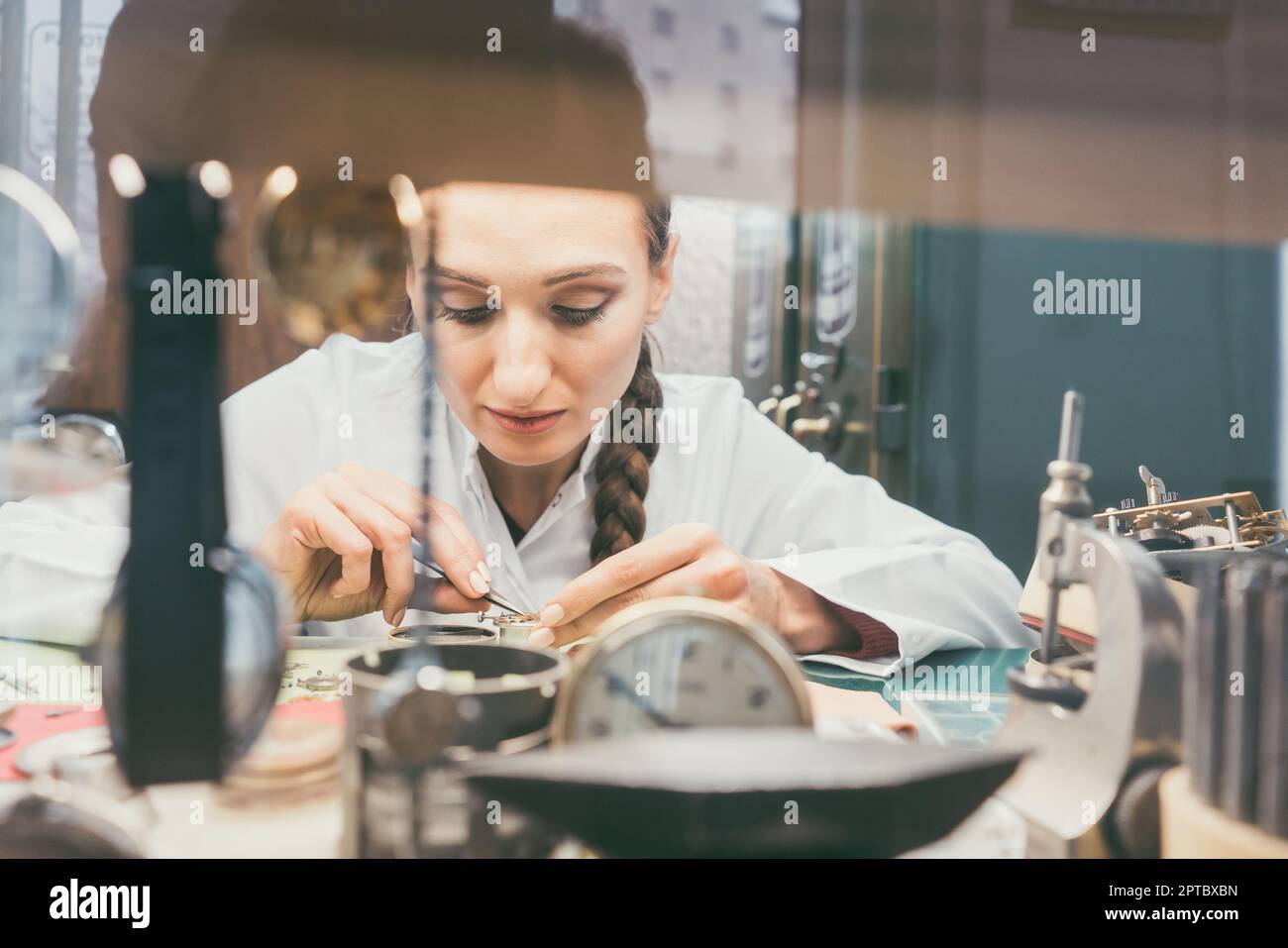 Diligent woman watchmaker working diligently on repairing a watch Stock ...
