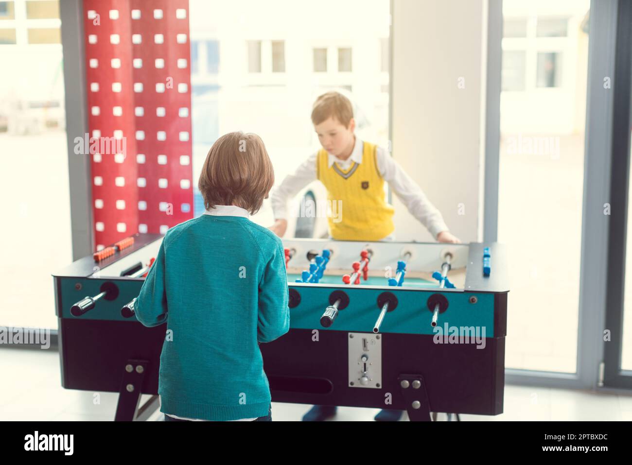 Two boy students in school break playing tabletop football Stock Photo ...