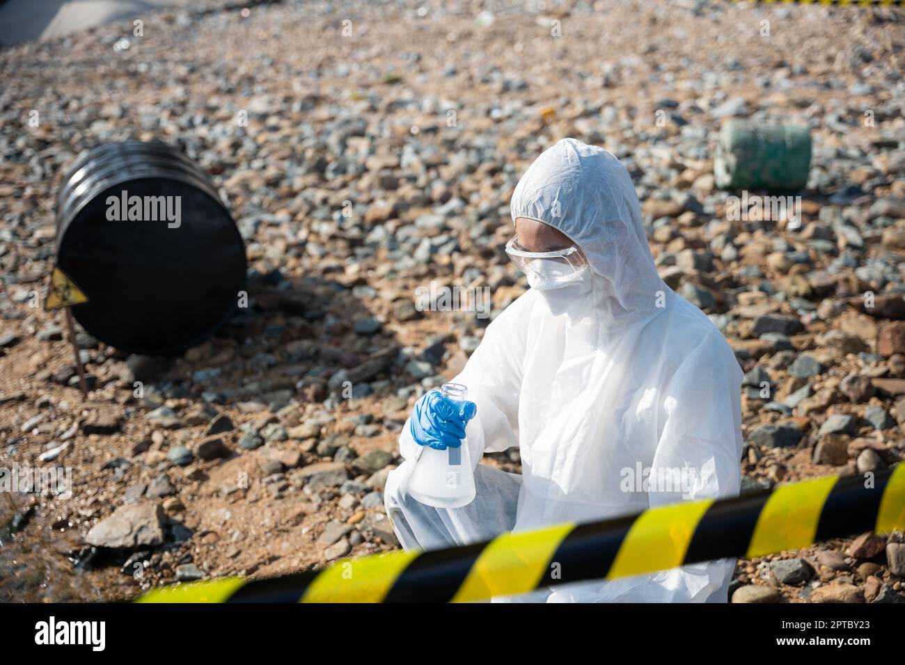 Ecologist sampling water from river with test tube glass and have white ...