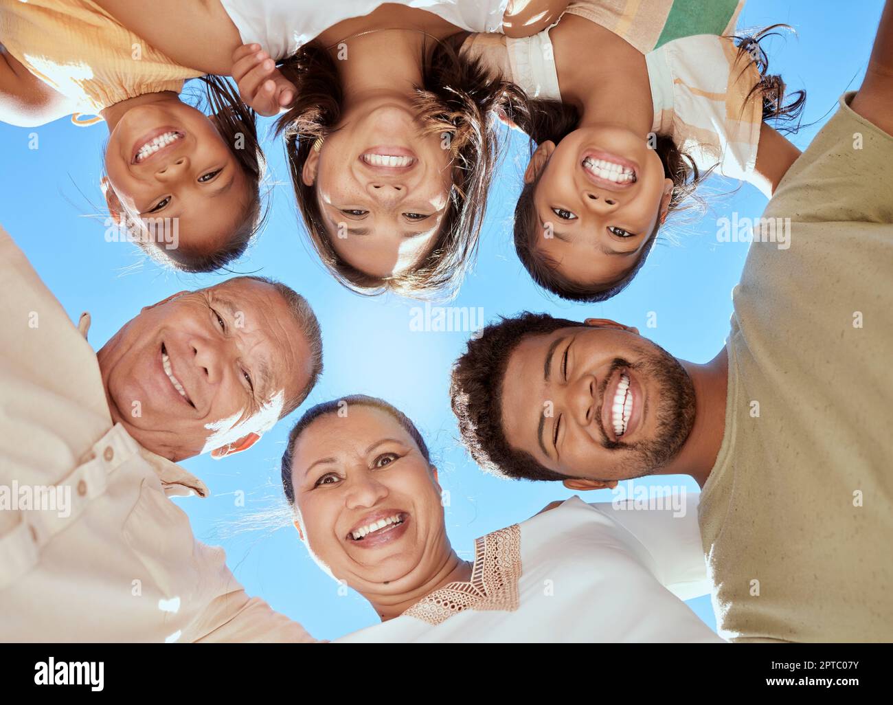 Happy family in a group huddle hi-res stock photography and images - Alamy