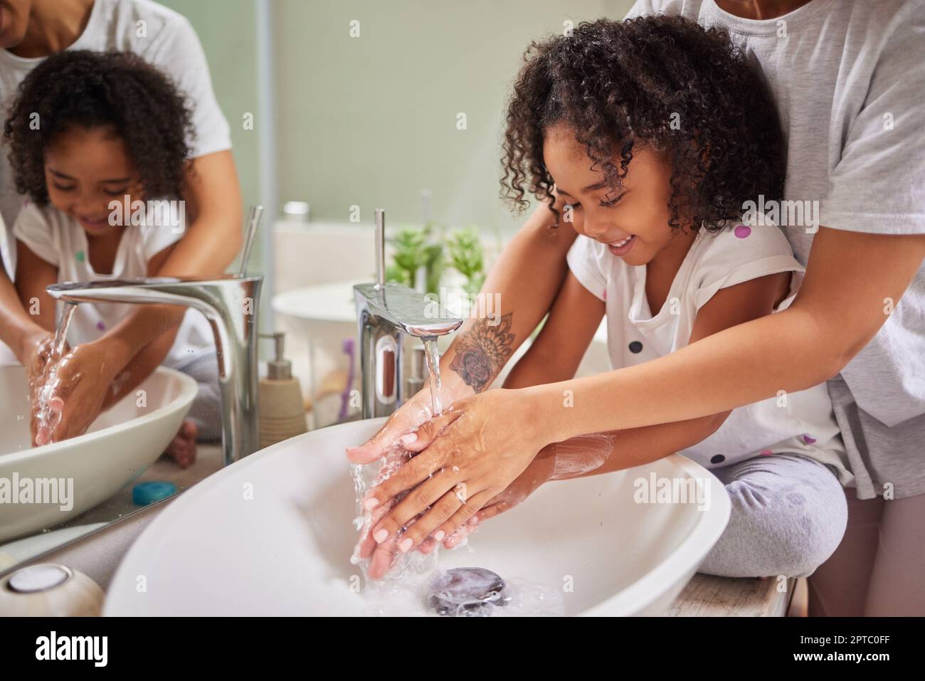 Child, washing hands and family rinsing, cleaning and good hygiene against bacteria or germs for ...