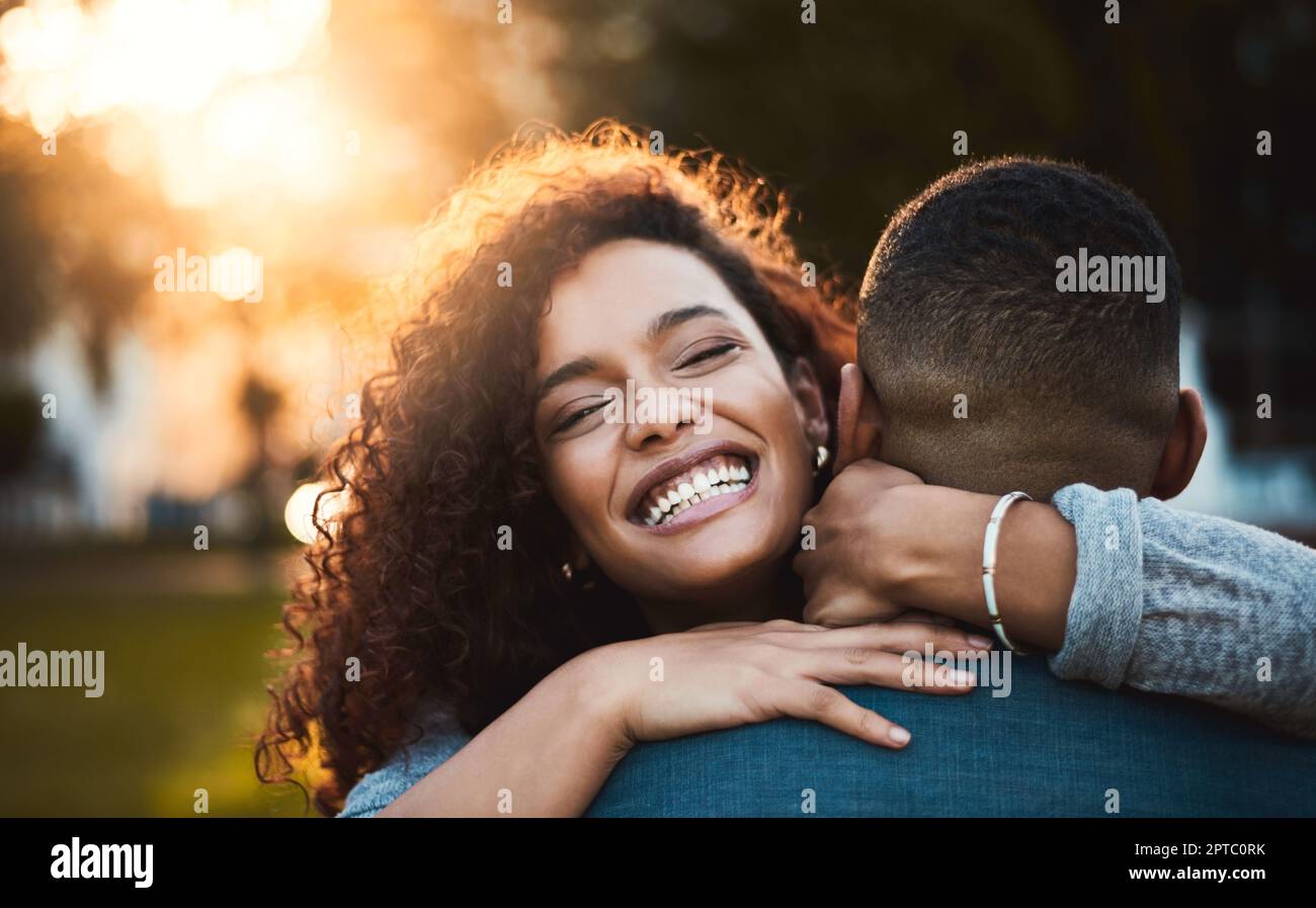 I smile because of you. Portrait of a young woman hugging her boyfriend outdoors Stock Photo - Alamy