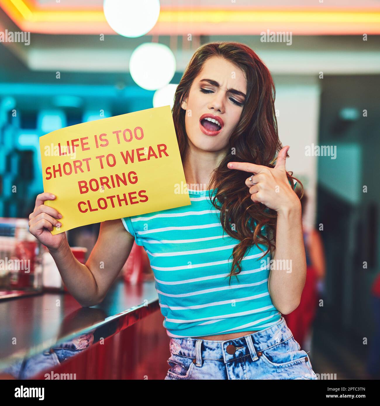 Heed this message. an attractive young woman holding up a sign in a ...