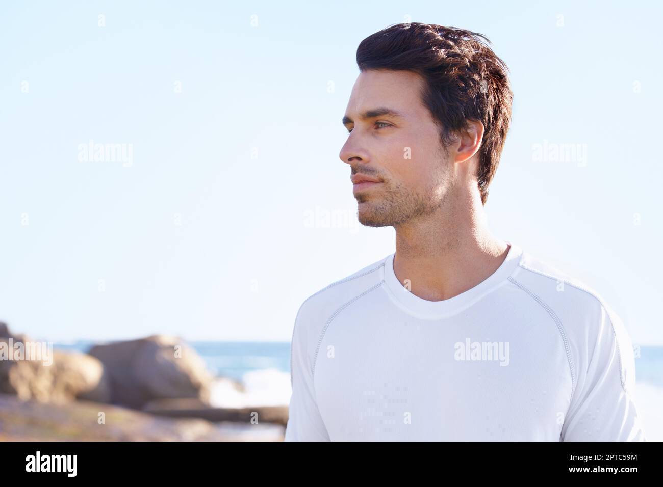 Getting back to nature. a young man enjoying a day at the ocean Stock ...