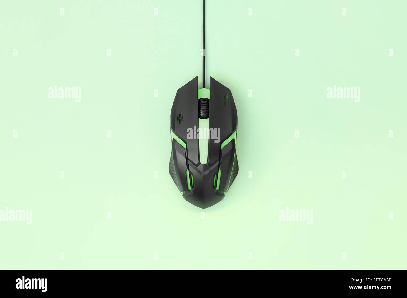 Black gaming optical mouse on a light green background. Device for ...