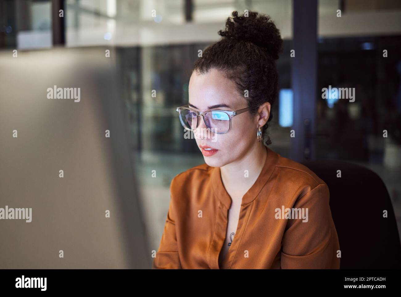 Woman, reading and glasses reflection in office at night, working on ...