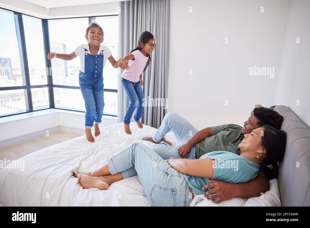 Relax, happy family and kids jump on bed mattress in Philippines home ...