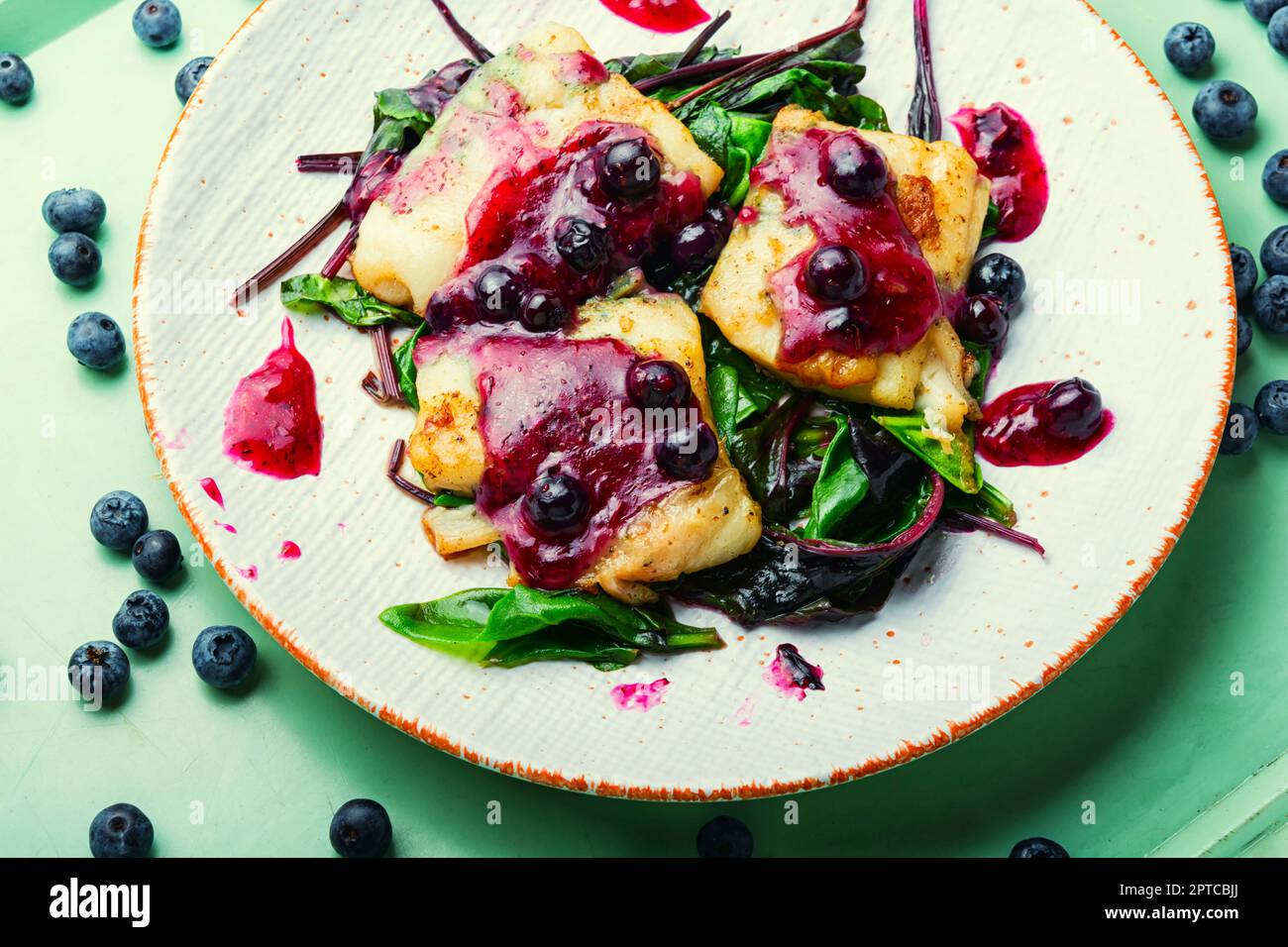 Delicious baked fish with berry sauce. Stewed pangasius with ...
