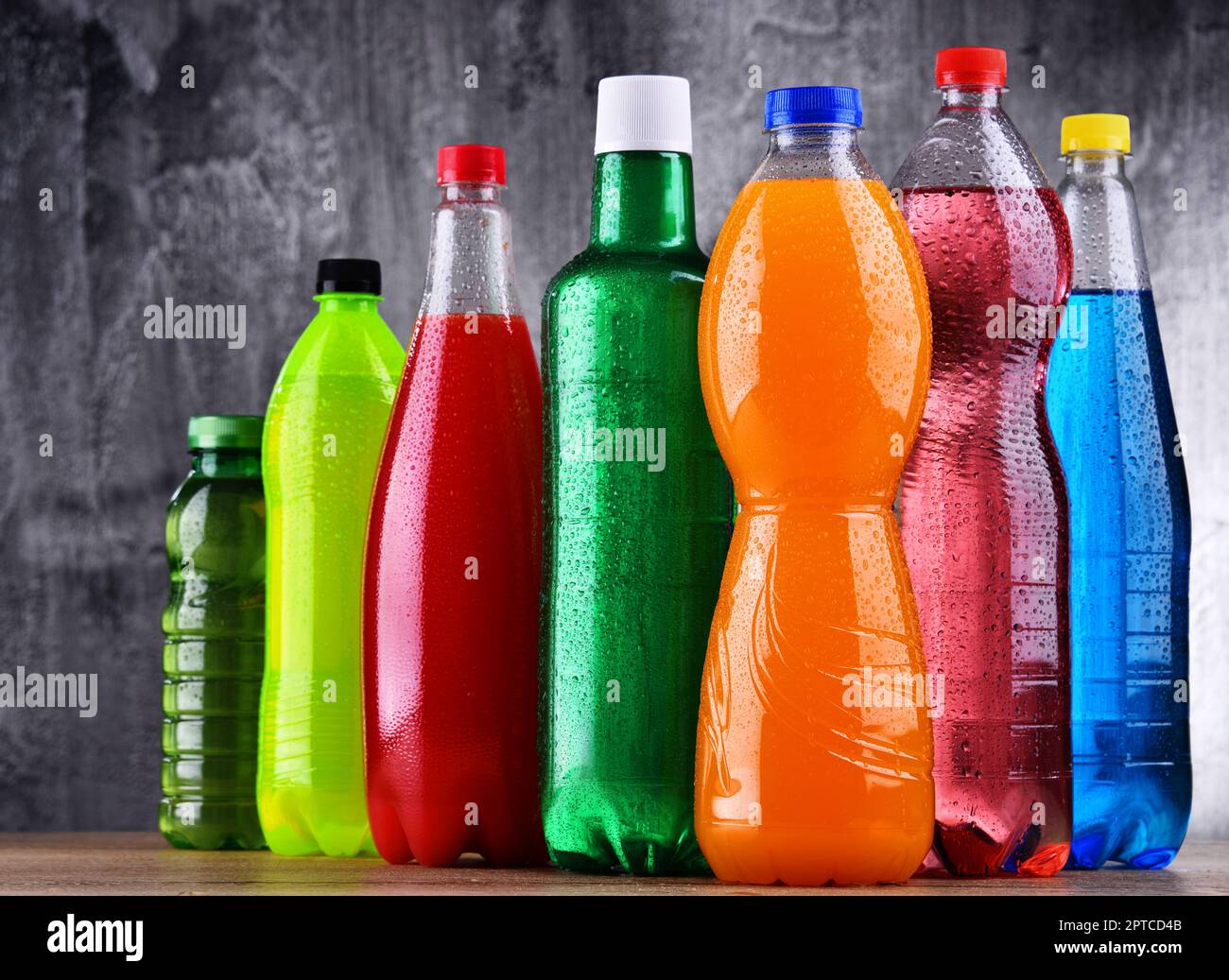 Plastic bottles of assorted carbonated soft drinks in variety of colors ...