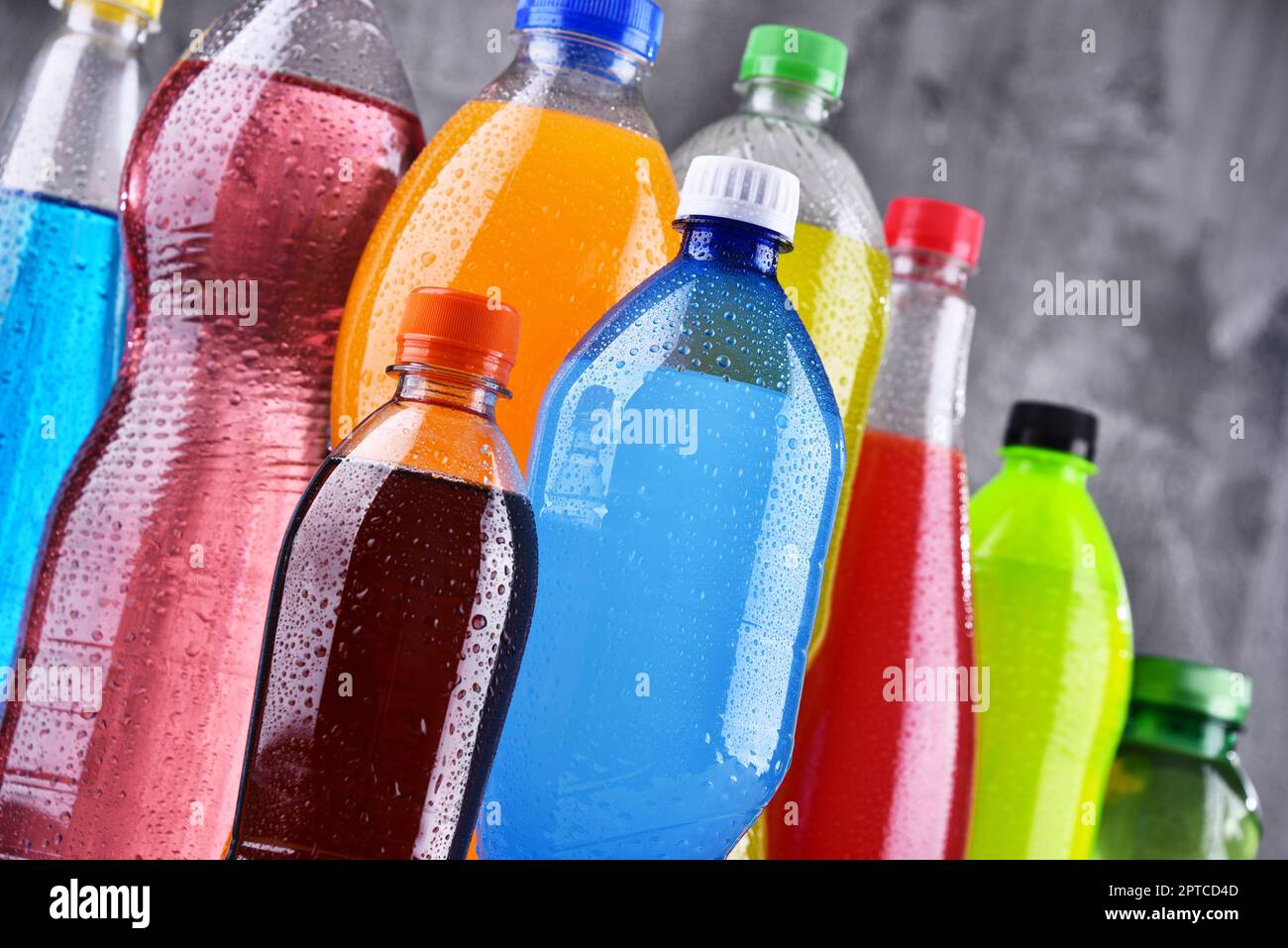 Plastic bottles of assorted carbonated soft drinks in variety of colors ...