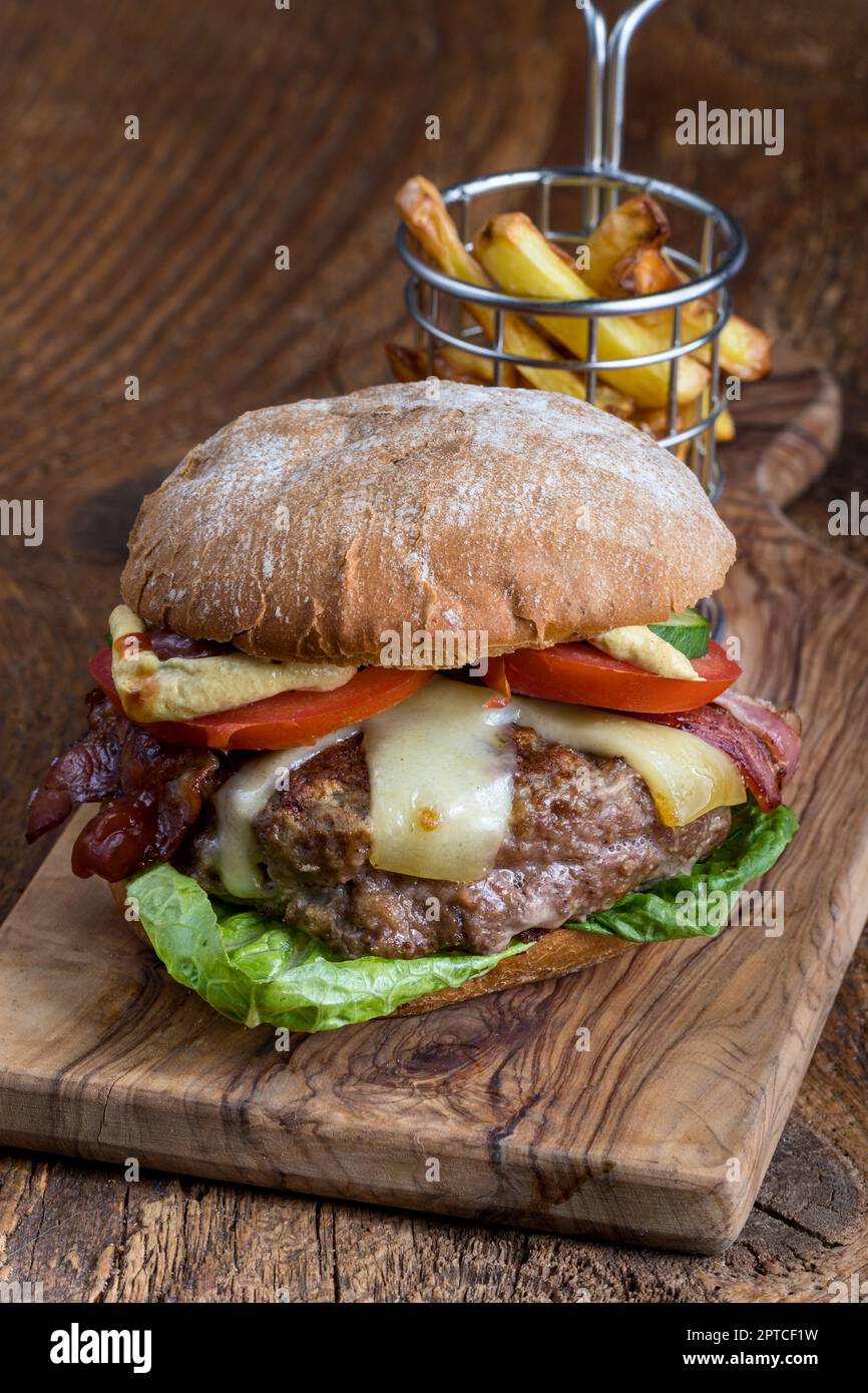 cheeseburger with fries on wood Stock Photo - Alamy