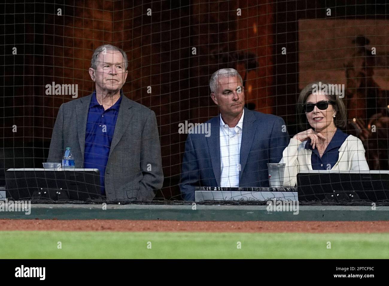 Former president George W. Bush, left, and Laura Bush, right, watch ...