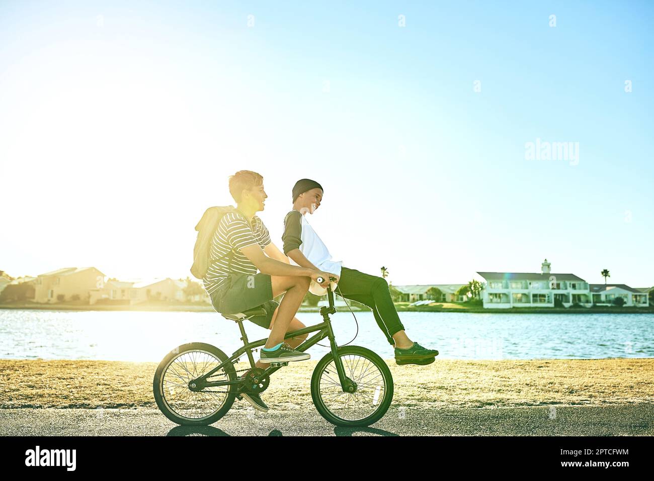 Hitching a ride. Full length shot of a young boy giving his younger ...
