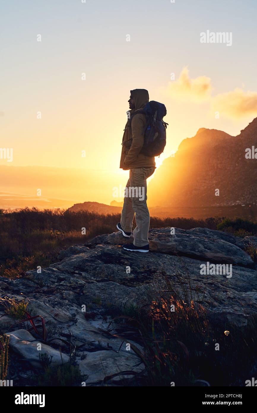 It is not the mountain we conquer but ourselves. a hiker on top of a ...