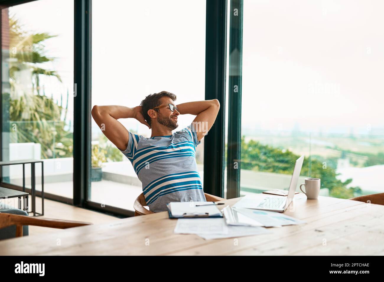 Hes feeling super relaxed. a handsome young male entrepreneur sitting ...