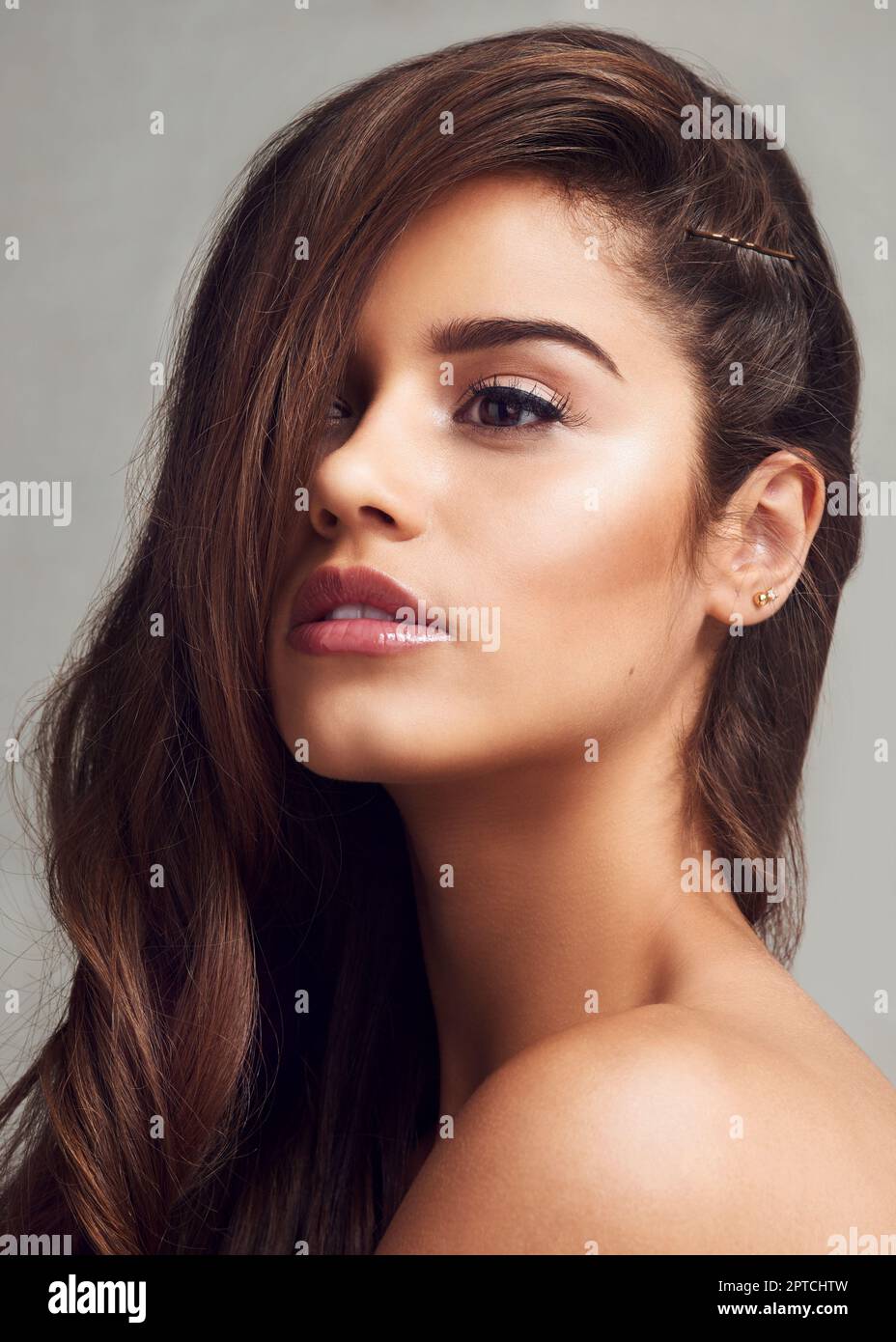 Shes a complete stunner. Studio shot of a young beautiful woman with long gorgeous hair posing ...