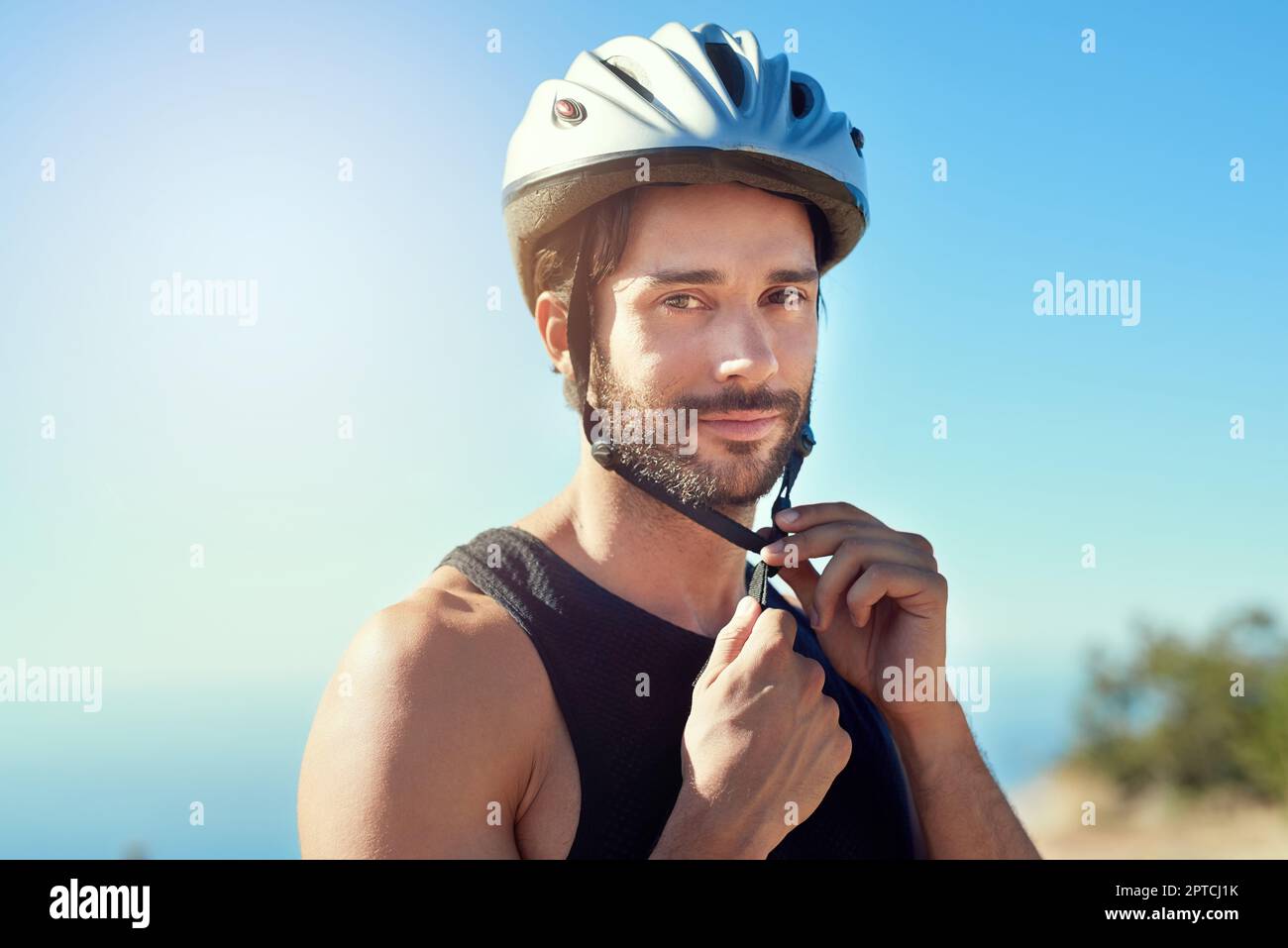 The helmet is an essential part of the cycling gear. a young man ...