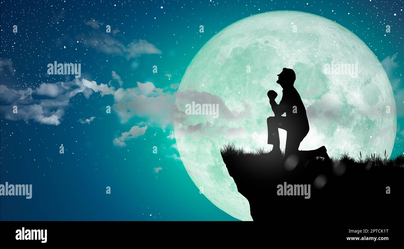 Silhouette at night landscape. A man is praying God on the cliff over ...