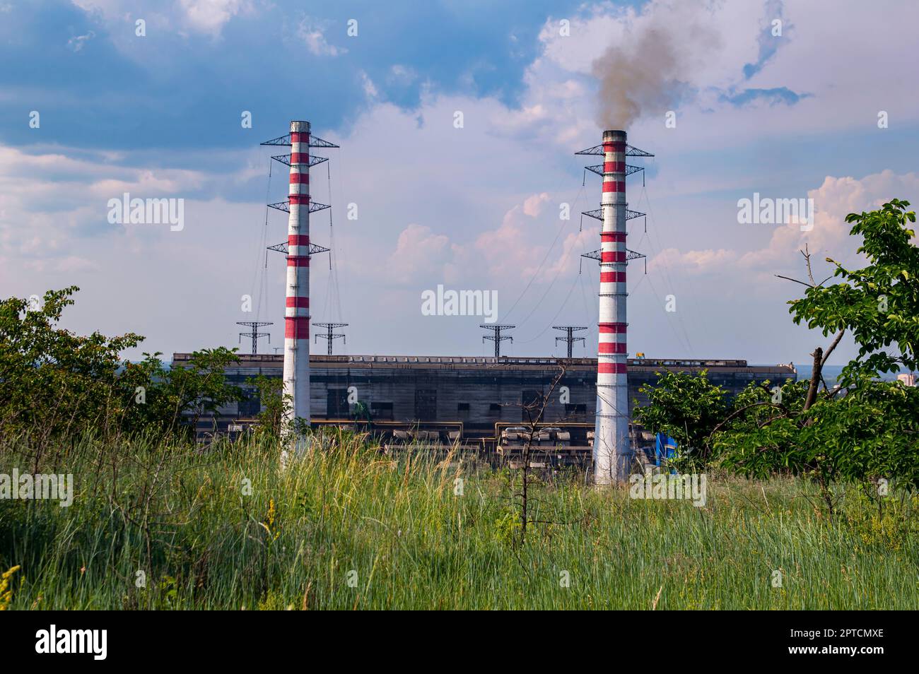 Smoking chimneys of a thermal power plant providing electricity to the ...