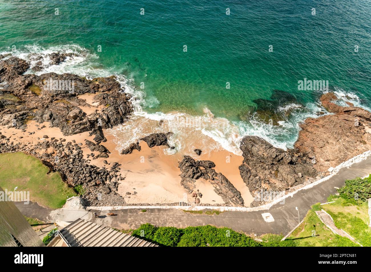 A small sandy beach on the ocean coast between stone cliffs Stock Photo ...