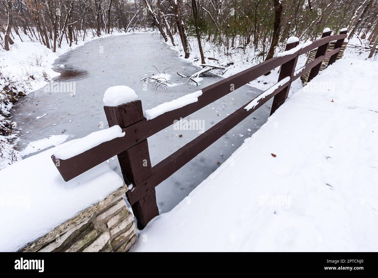 Rustic Bridge Over Frozen River In Winter Stock Photo - Alamy
