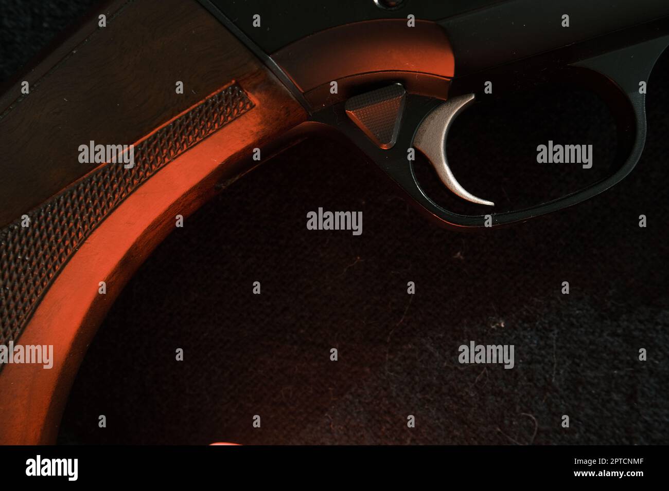 Trigger of a rifle on black background with red lightning Stock Photo ...