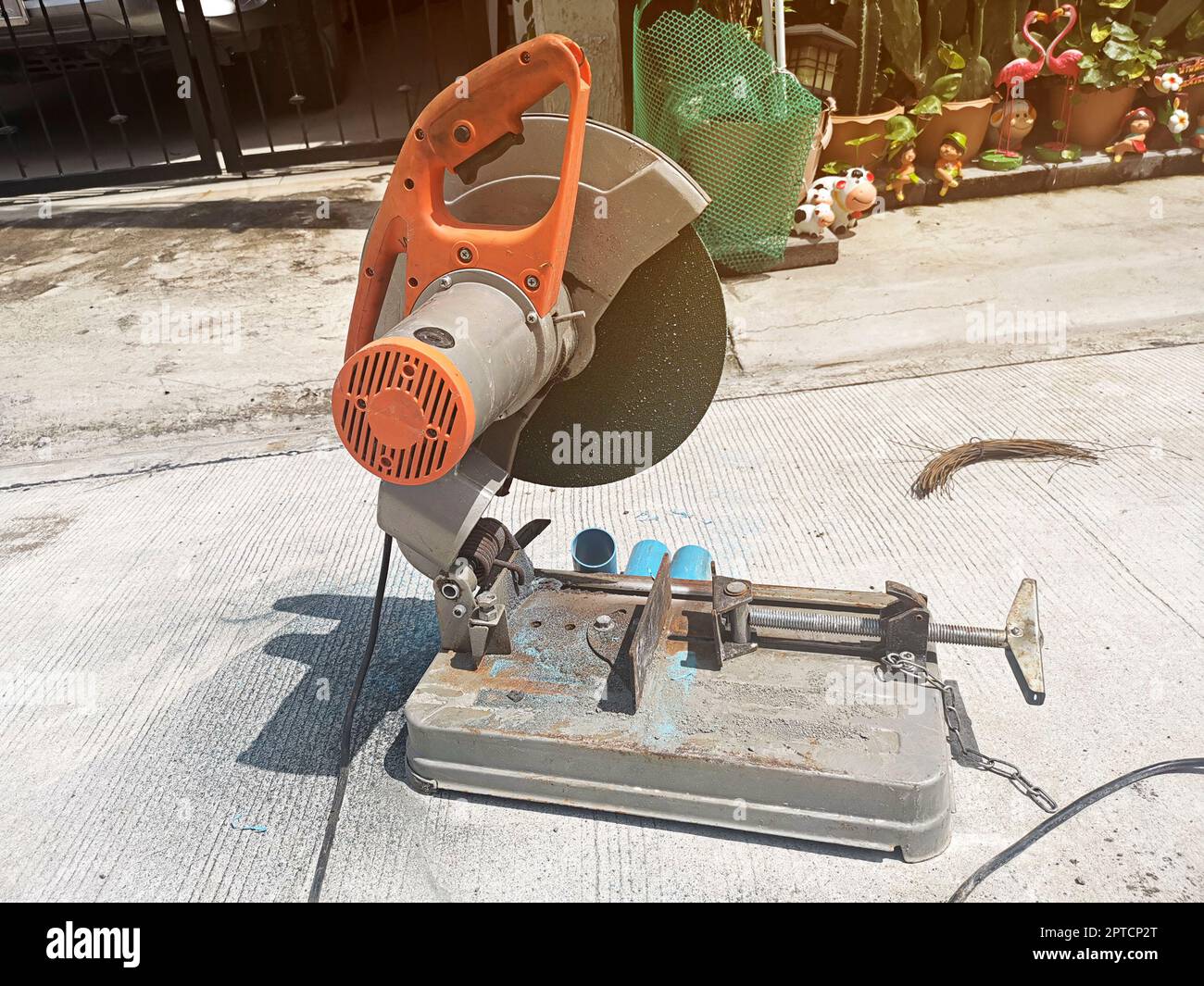 Old rusty sawing machine on the concrete floor at the house under ...