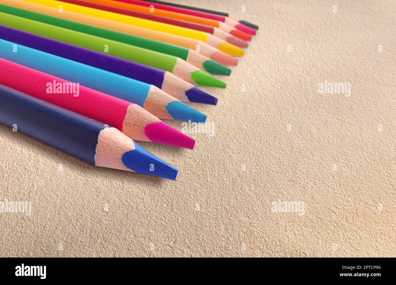 colored pencils on a brown paper texture background Stock Photo - Alamy