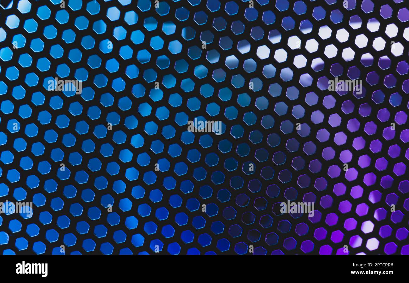 Led lights shines through the ventilation grid holes of computer air ...