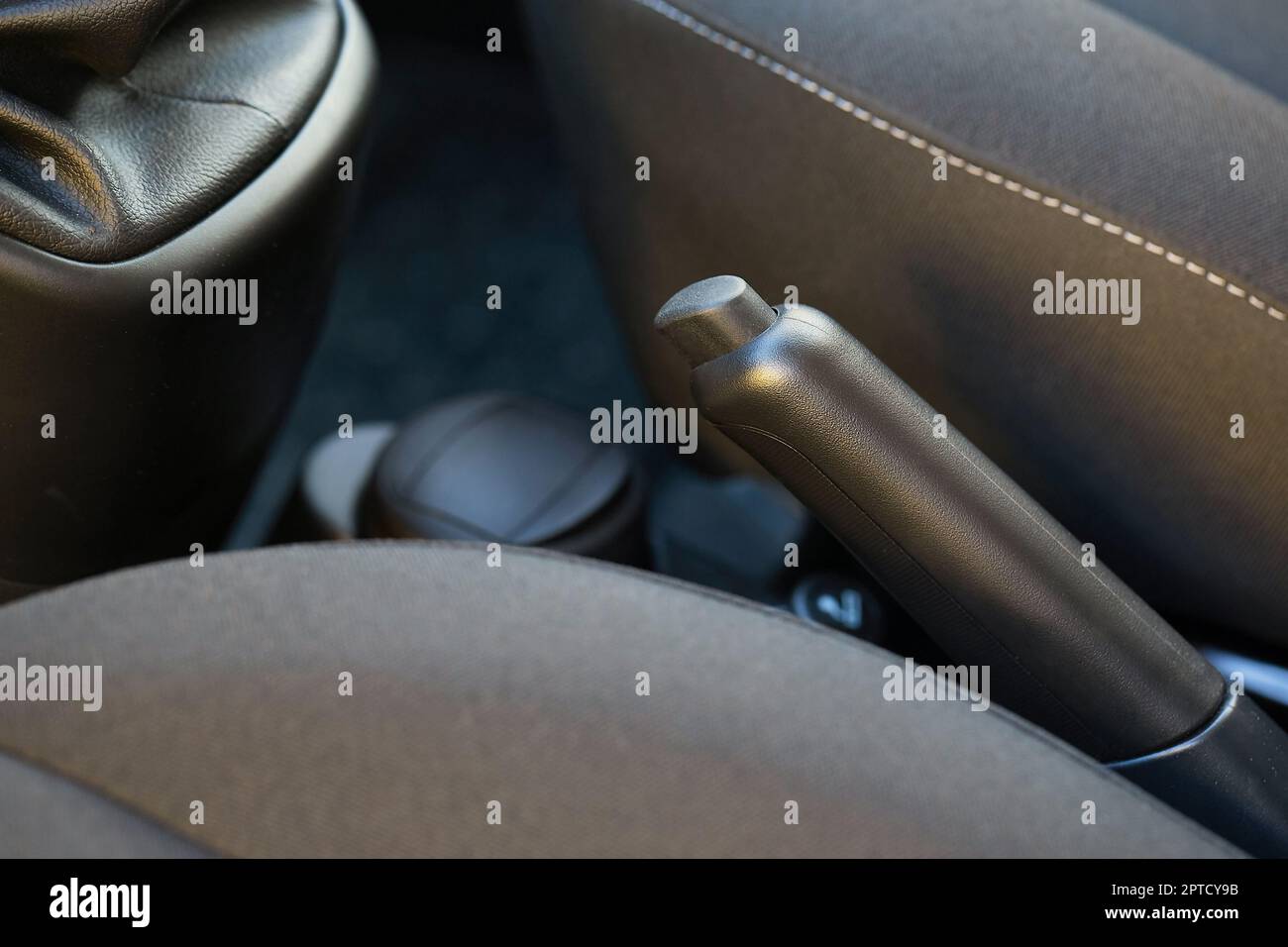Handbrake parking brake lever in a cheap car Stock Photo - Alamy