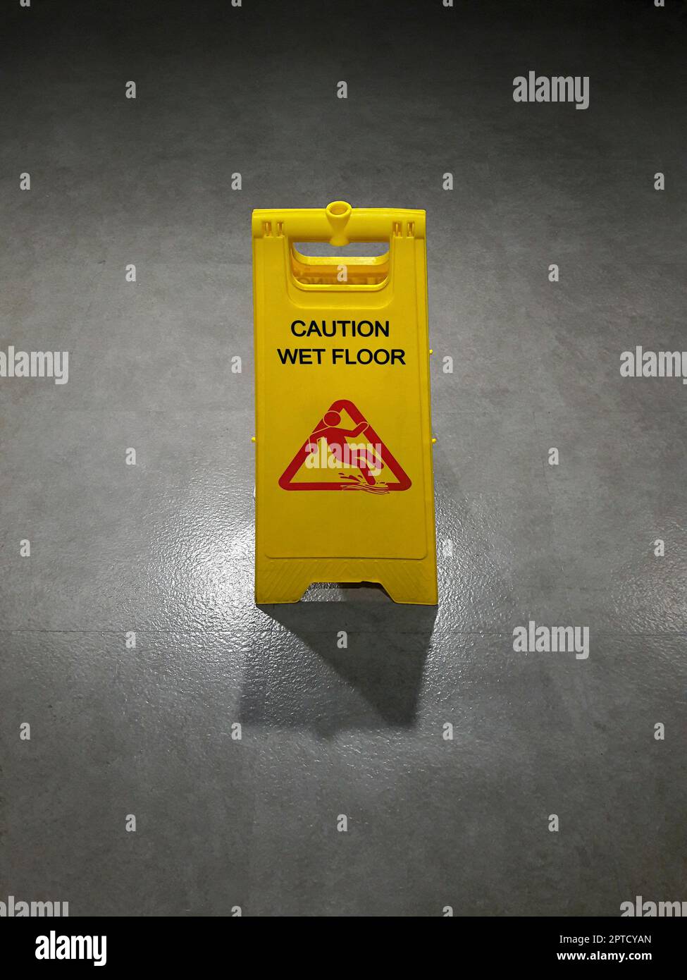 Warning sign is clean yellow On the cement floor Stock Photo - Alamy