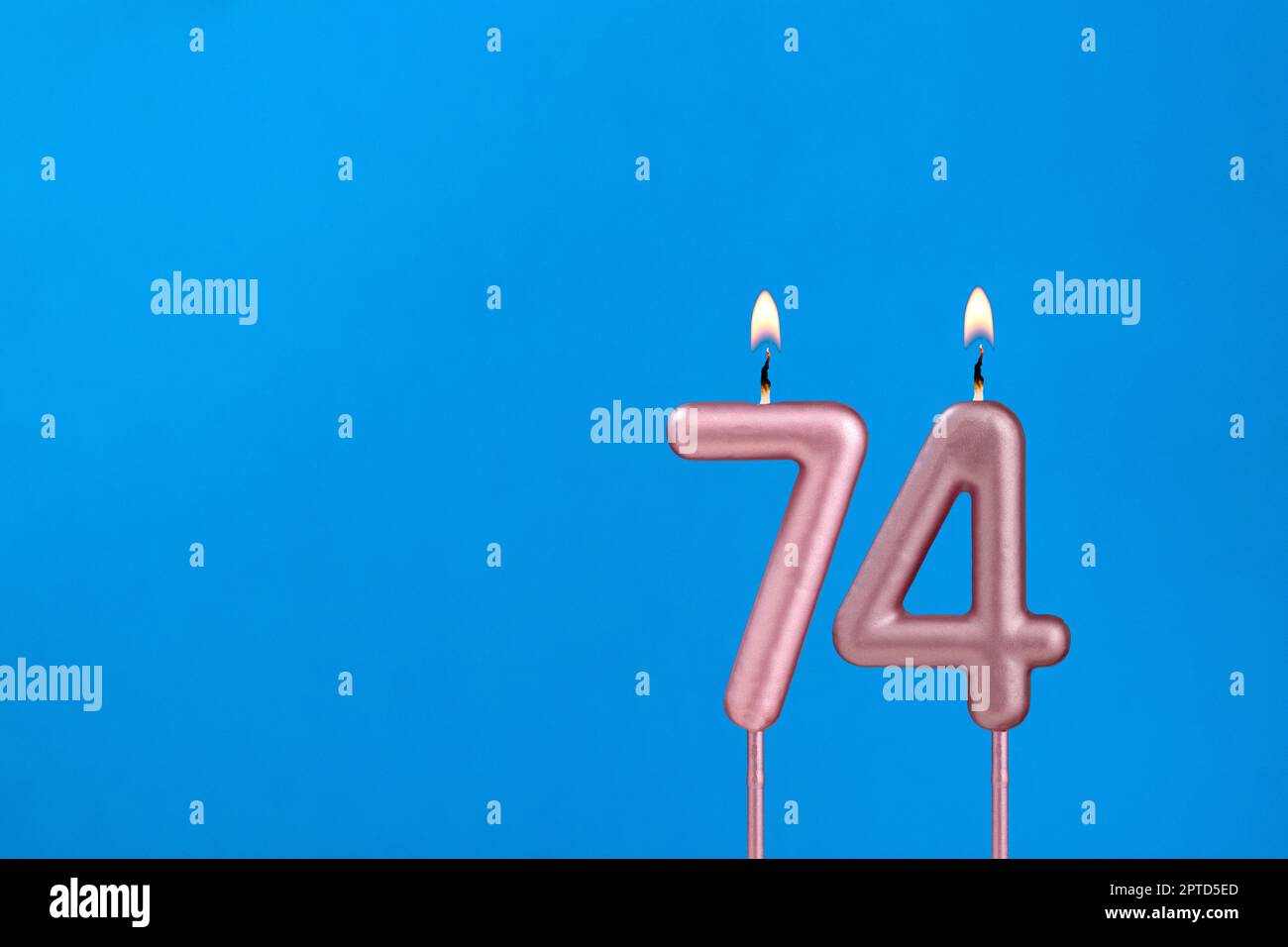 Candle number 74 - Birthday in blues foamy background Stock Photo - Alamy