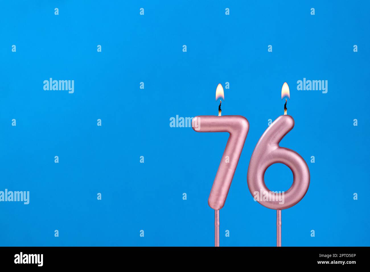 Candle number 76 - Birthday in blues foamy background Stock Photo - Alamy