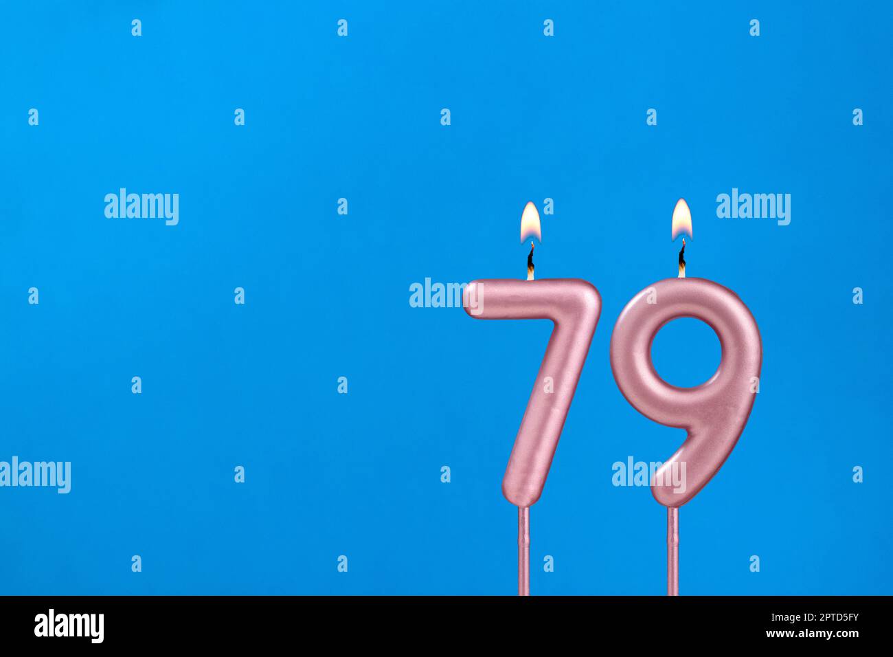 Number 79 - Burning anniversary candle on blue foamy background Stock ...