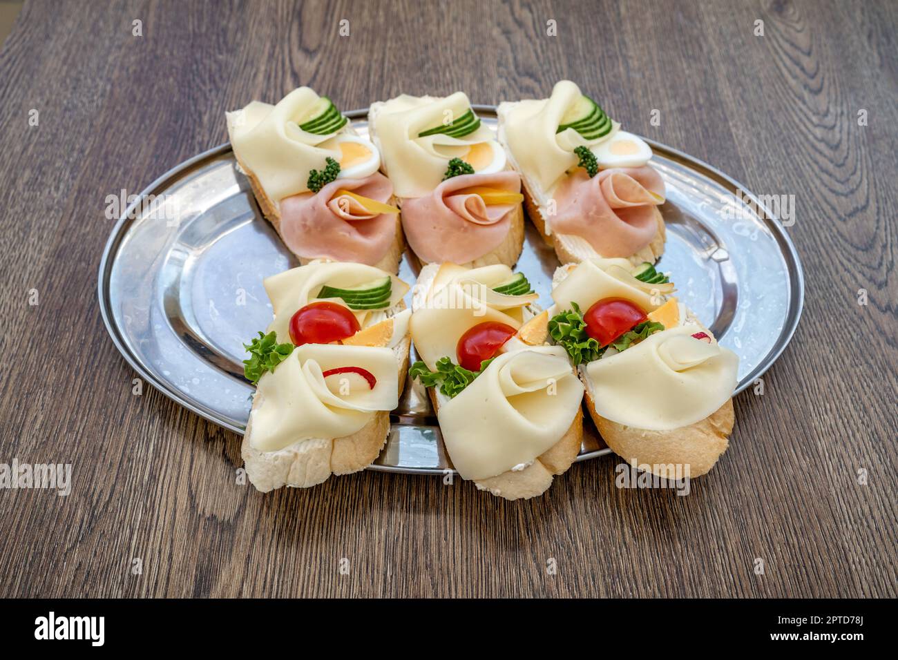 a variation of bread with a spread of cheese, egg and vegetables Stock ...
