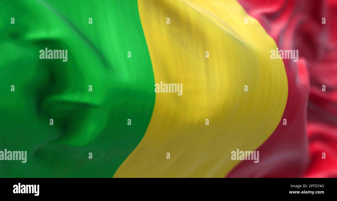 Close-up view of the Mali national flag waving in the wind. The ...