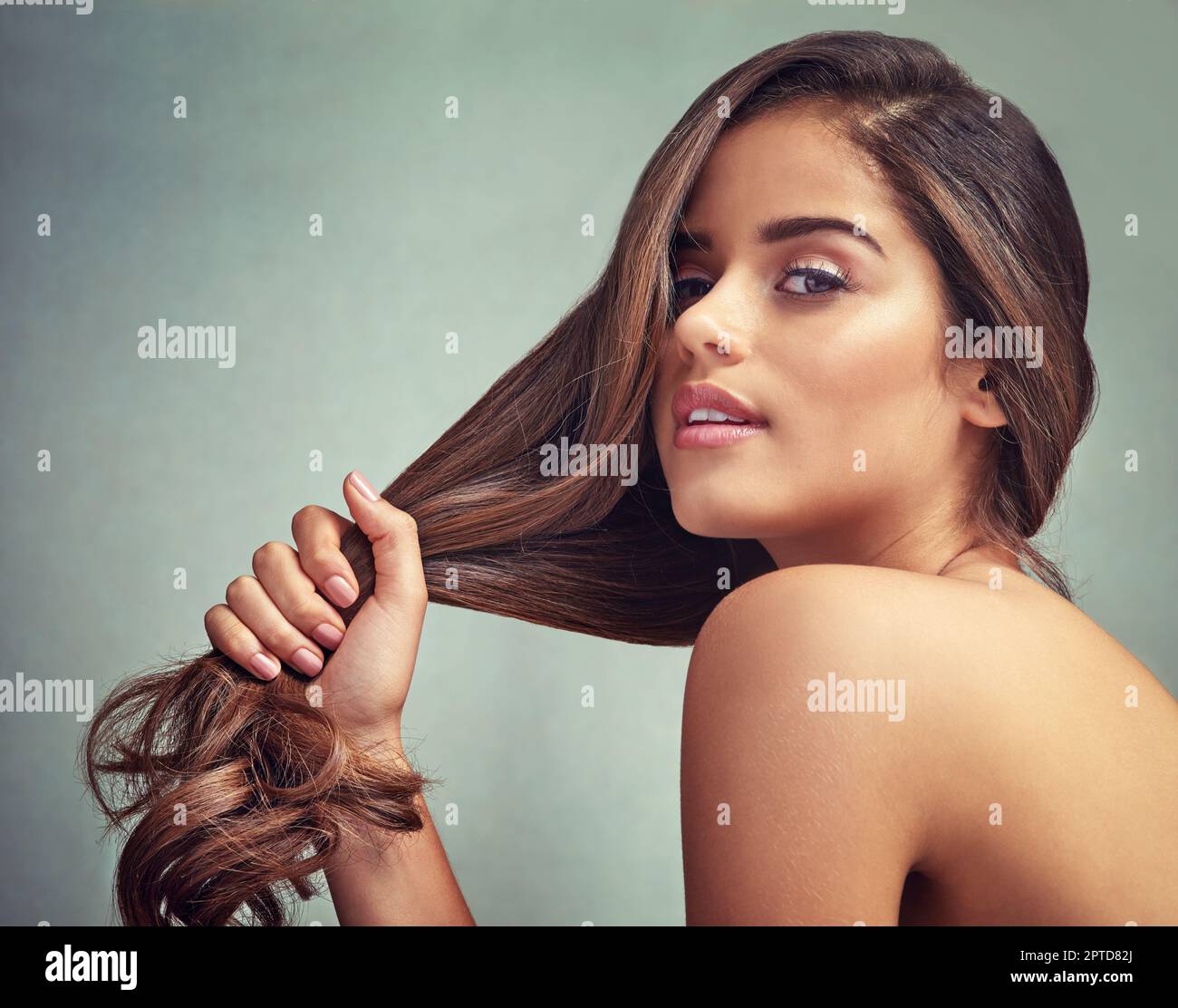 Perfectly pulling off the no makeup look. Studio portrait of a beautiful woman with long locks ...