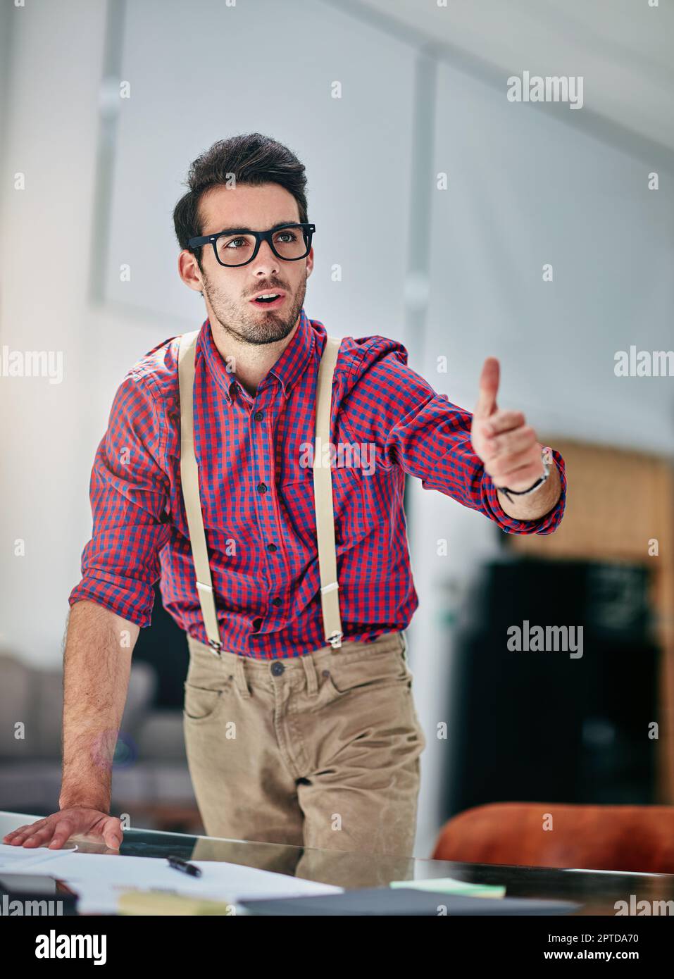 Good stuff. a handsome young designer giving thumbs up to a coworker in ...