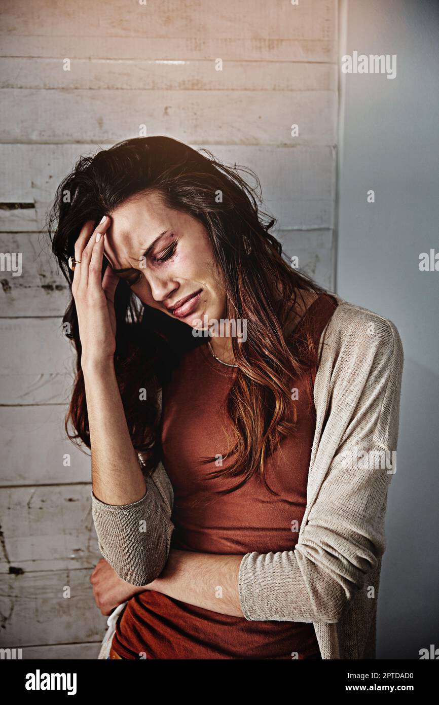 Crying is her only course of action. a beaten and bruised young woman ...