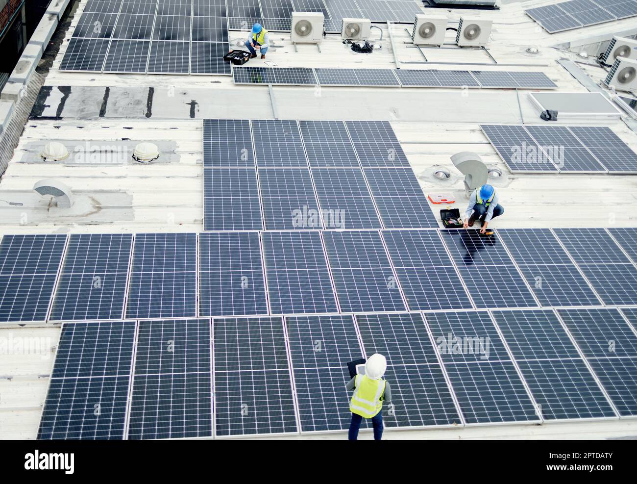 Grid, solar energy and roof construction engineering people working on ...
