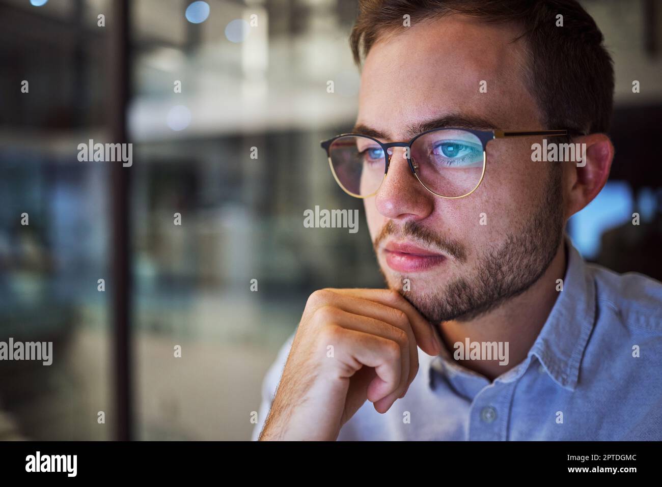 Man, work and reading with reflection on glasses in office thinking of ...
