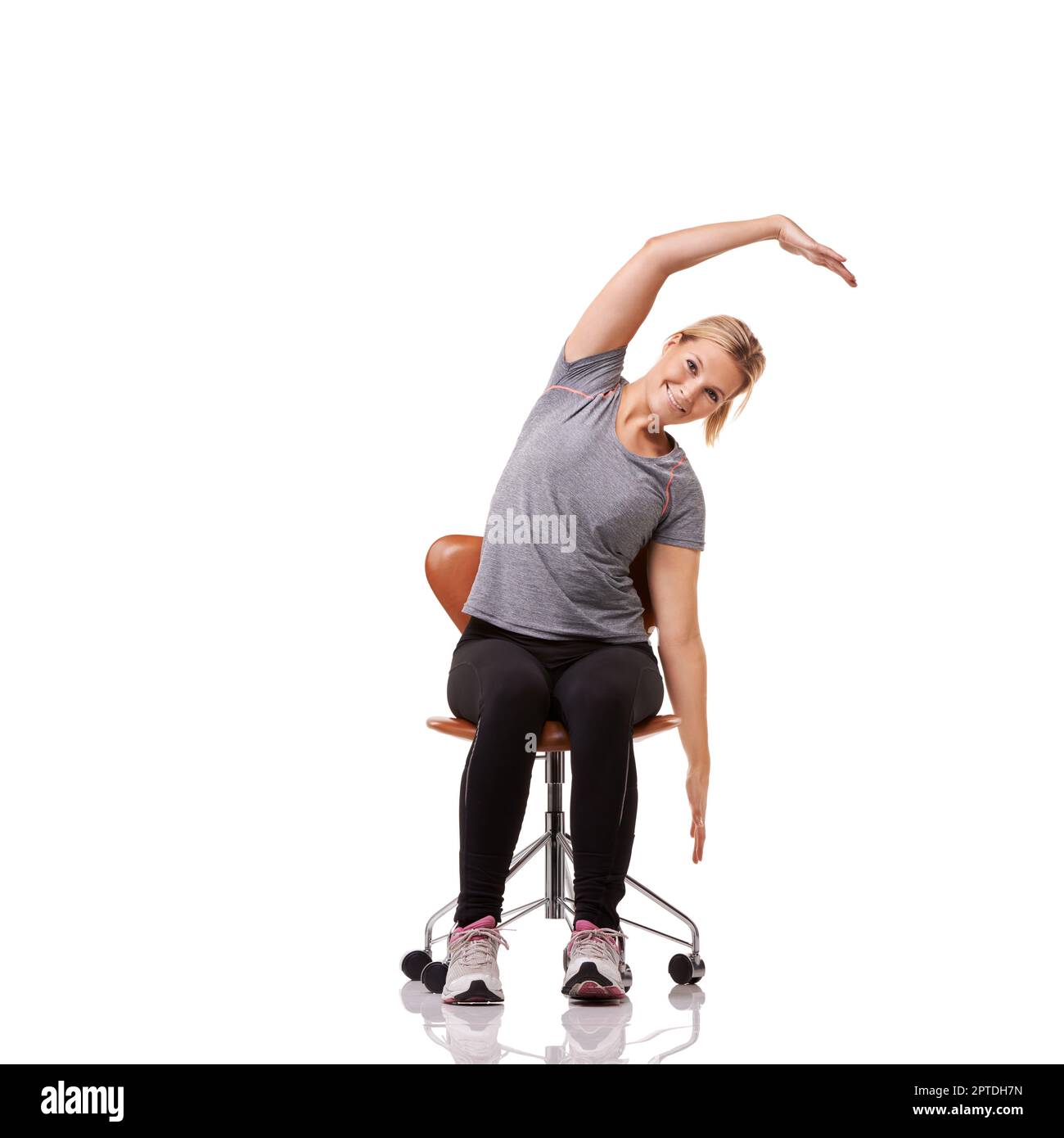 Perfect for your posture. a sporty woman doing stretches on a chair ...