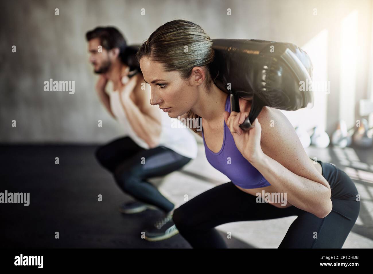 Go do something that makes you sweat. two young people working out in ...