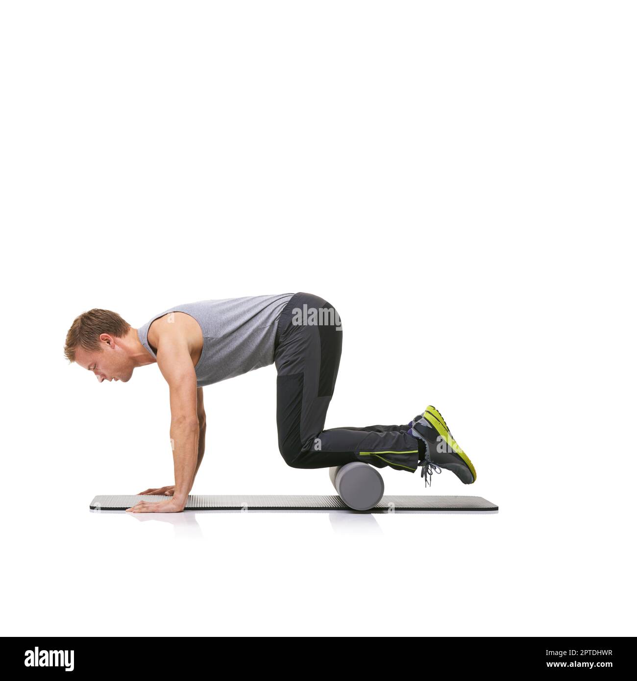 Maintaining balance. A young man doing push-ups on his exercise mat ...
