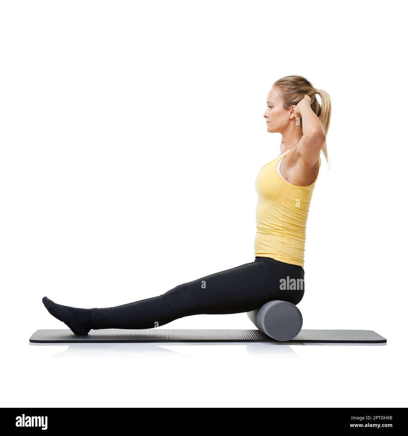 Working out alongside copyspace. A young woman sitting on a foam roller ...
