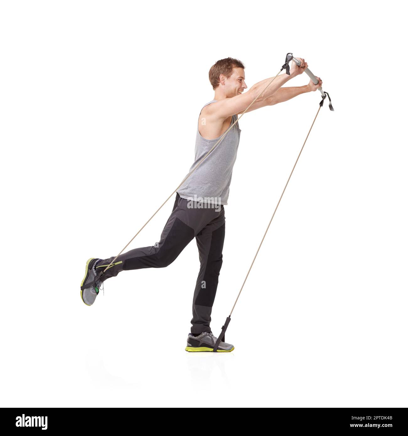 Reaching for a higher level of fitness. A young man using a resistance ...