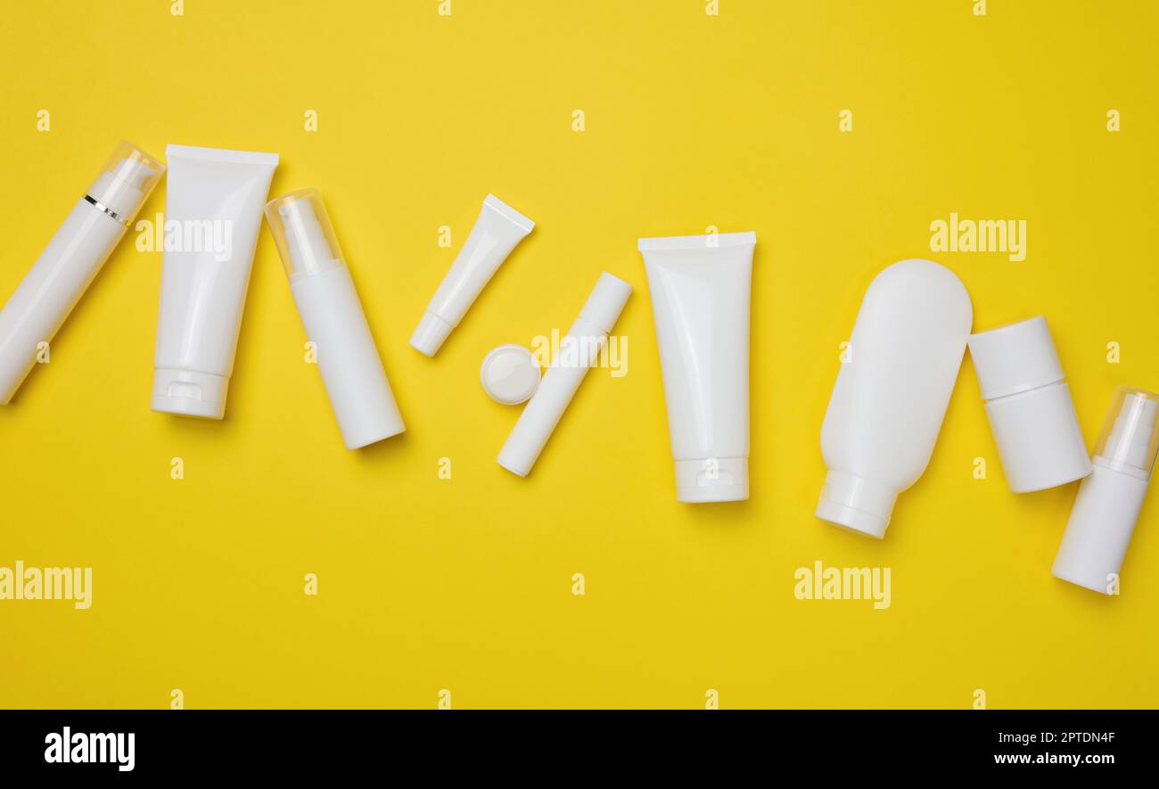 Various types of white plastic packaging: a bottle, a jar, a tube on a ...