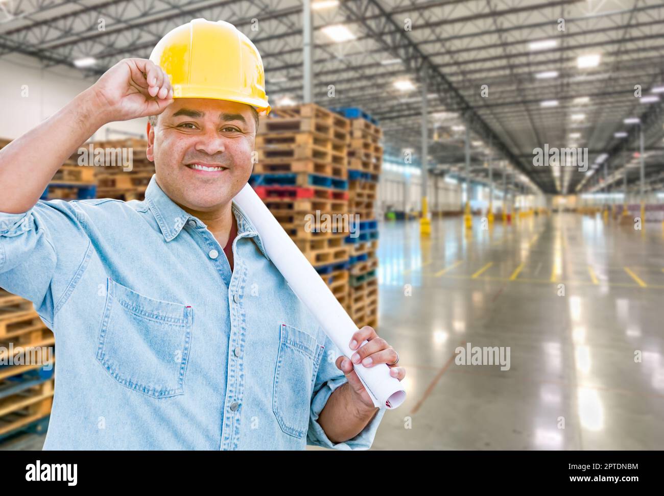 Hispanic Male Contractor Wearing Hard Hat Standing in Empty Industrial ...